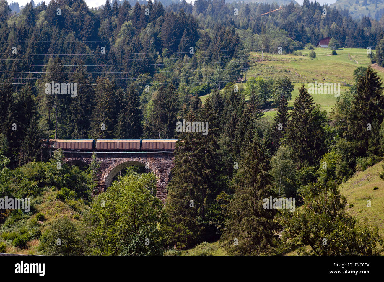 A picturesque Alpine landscape with an old railway bridge. Austria ...