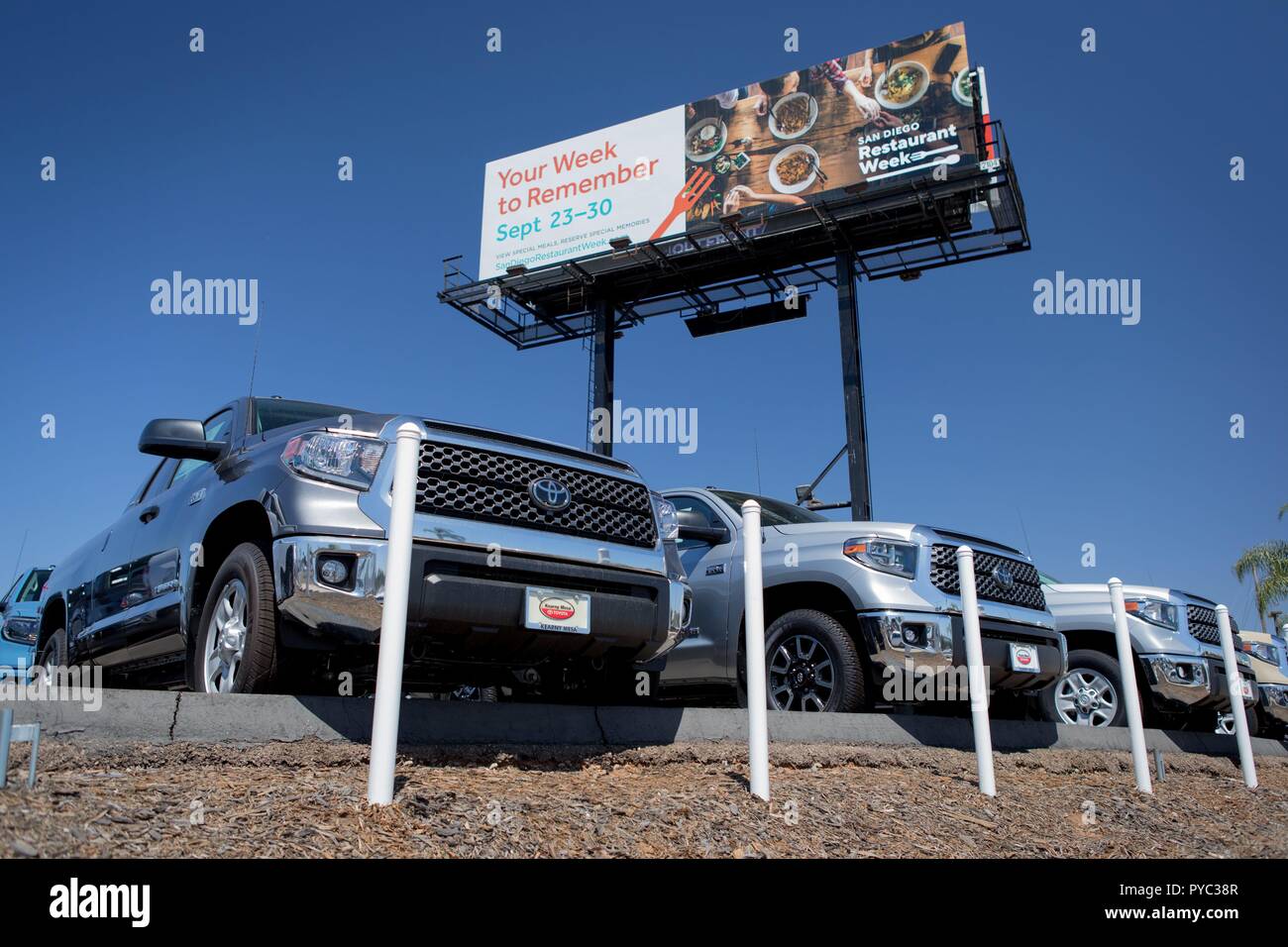 SUVs lined up under a huge billboard at a Toyota dealership in Kearny ...