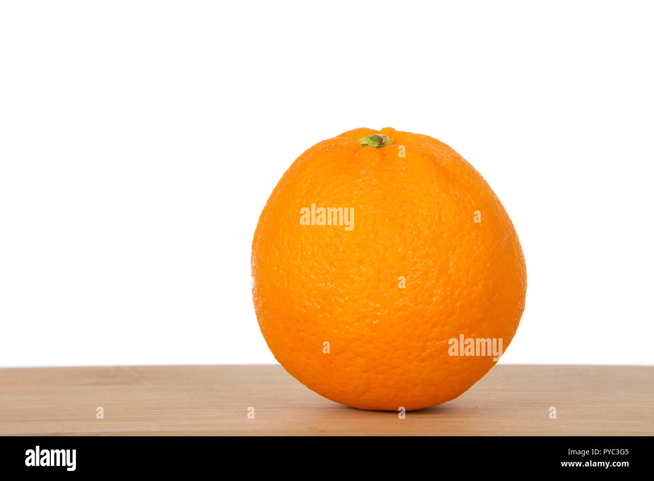 One organic fresh naval orange laying on a wood table isolated on white ...