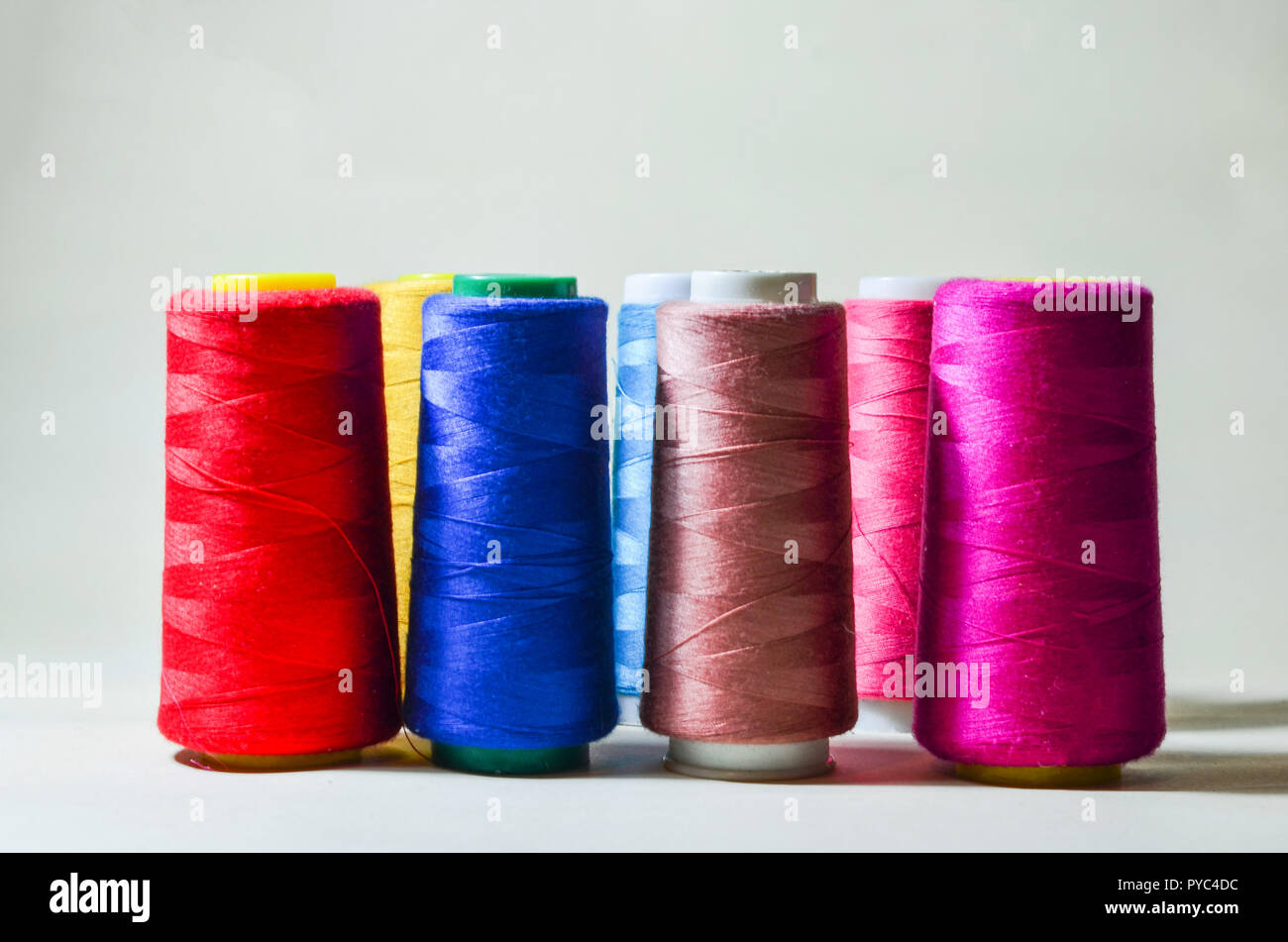 Spools with color threads. Threads of all colors. Isolated. White ...