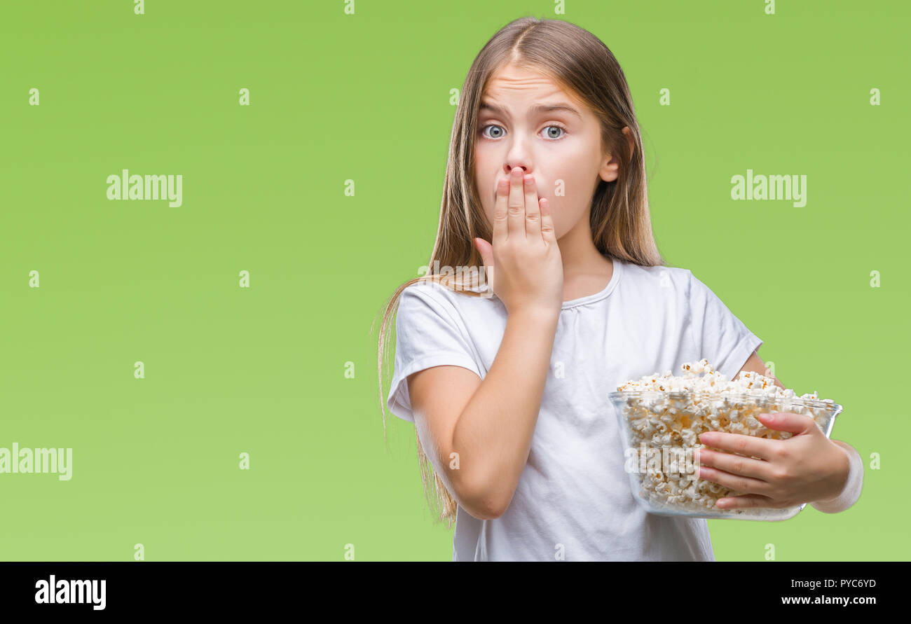Young beautiful girl eating popcorn snack isolated background cover ...