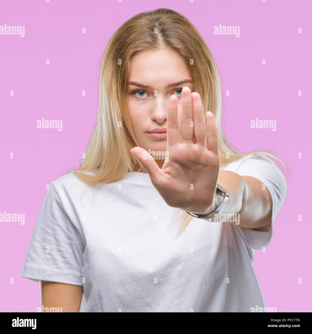 Young caucasian woman over isolated background doing stop sing with ...