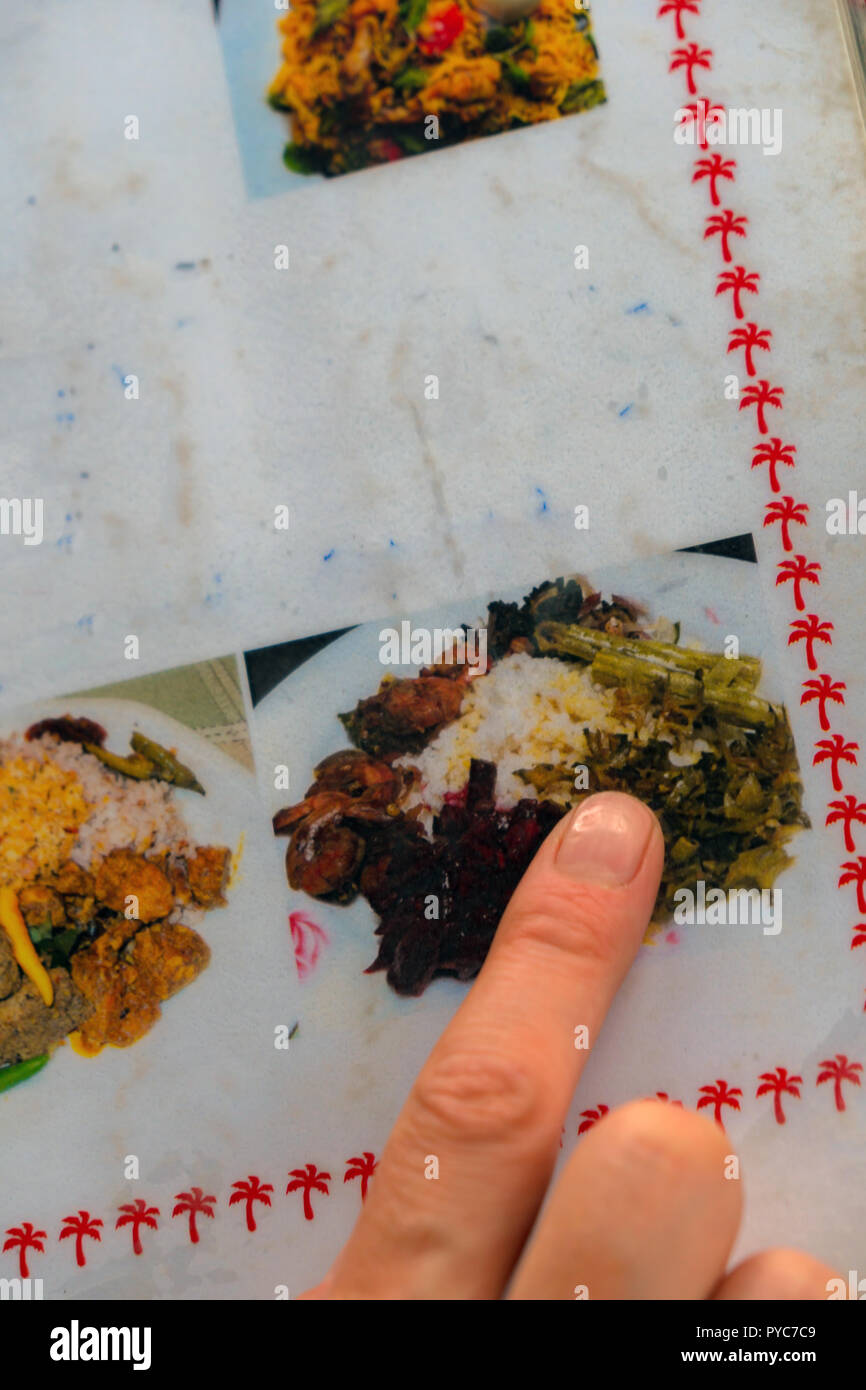 The finger points to the dish in the menu Stock Photo - Alamy