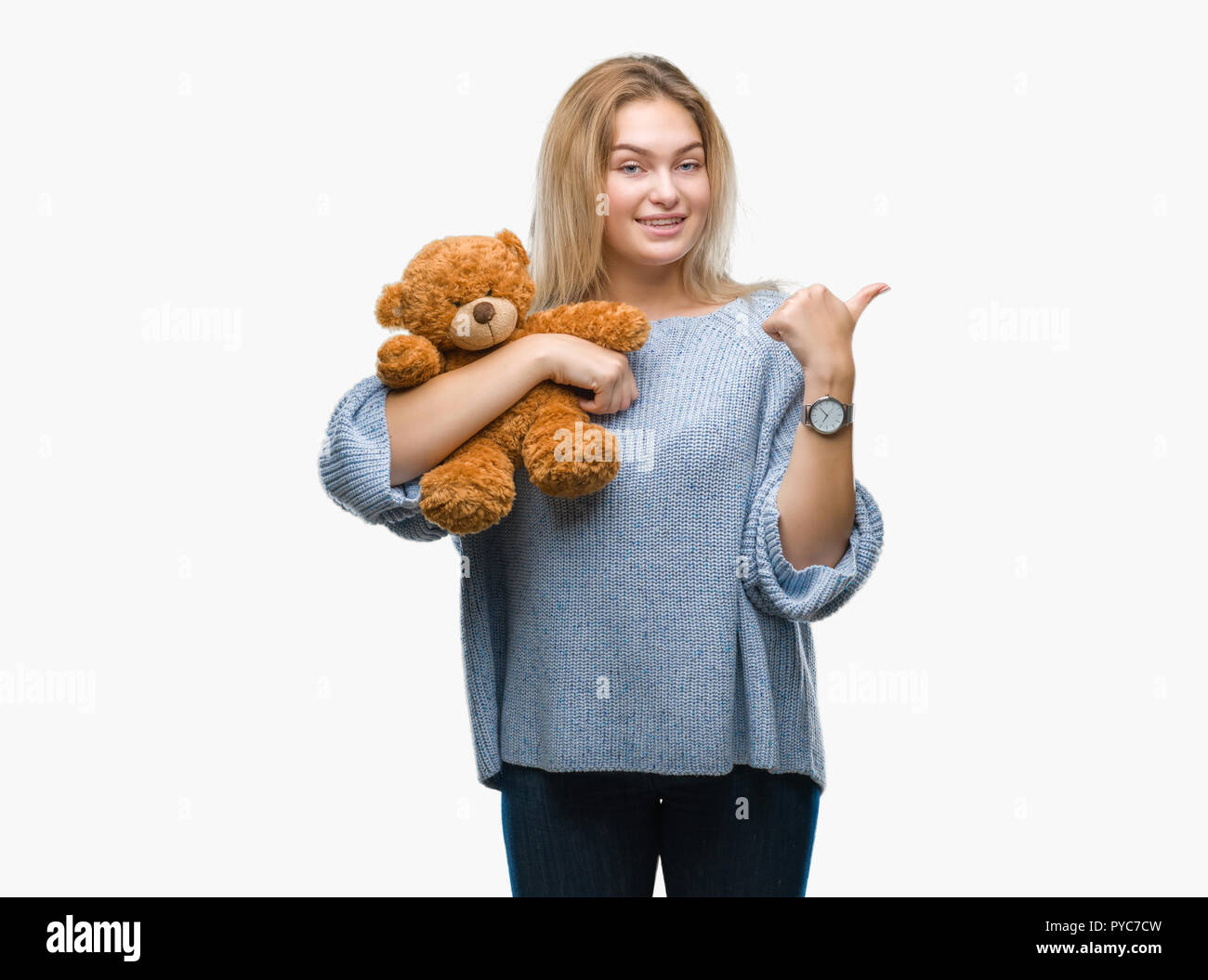 Young caucasian woman holding cute teddy bear over isolated background ...