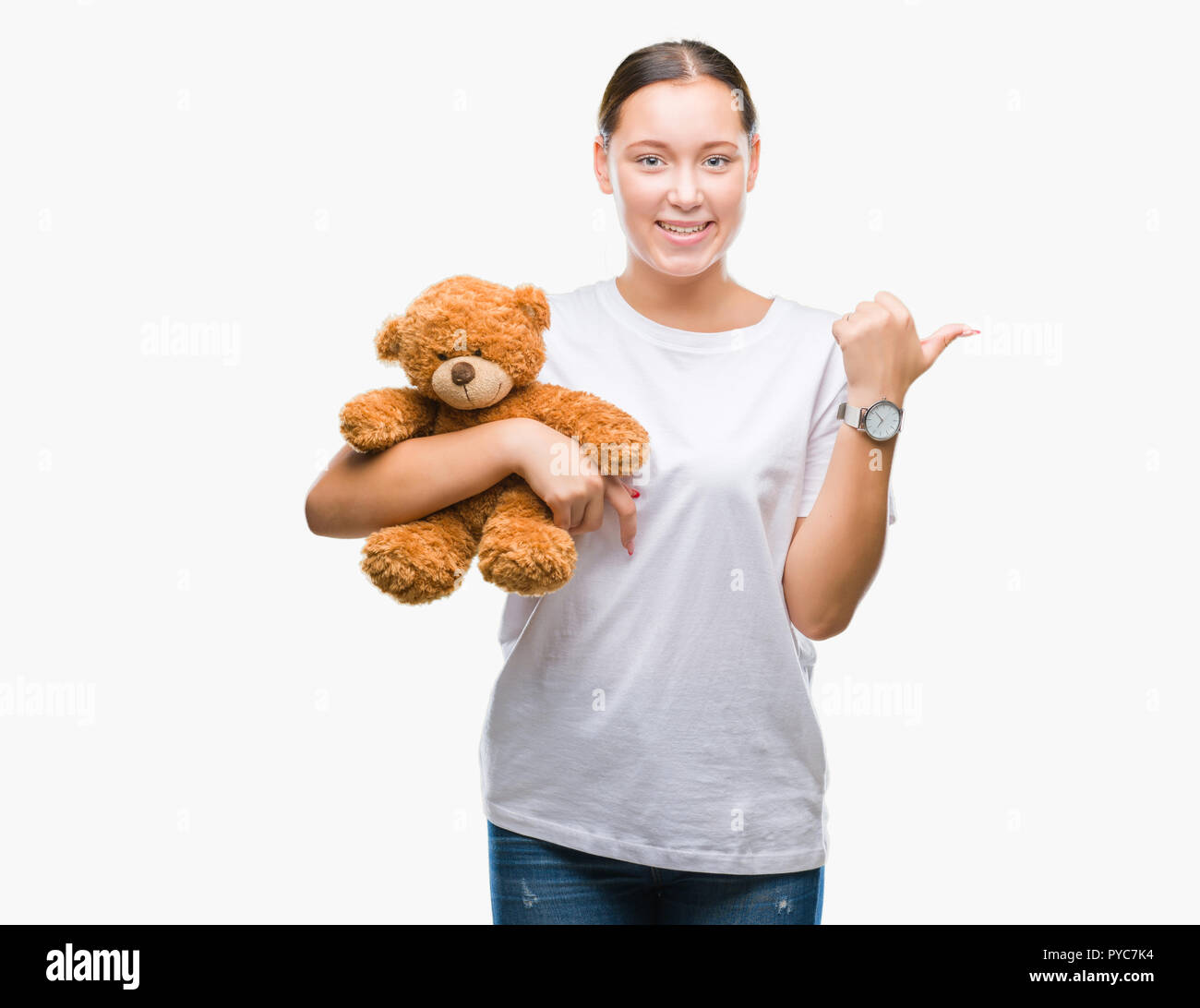 Young caucasian woman holding teddy bear over isolated background ...