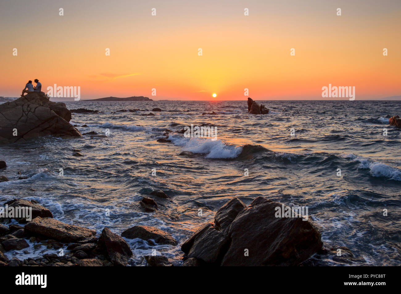 Sunset from Little Venice in Mykonos island with wavy sea and beautiful ...