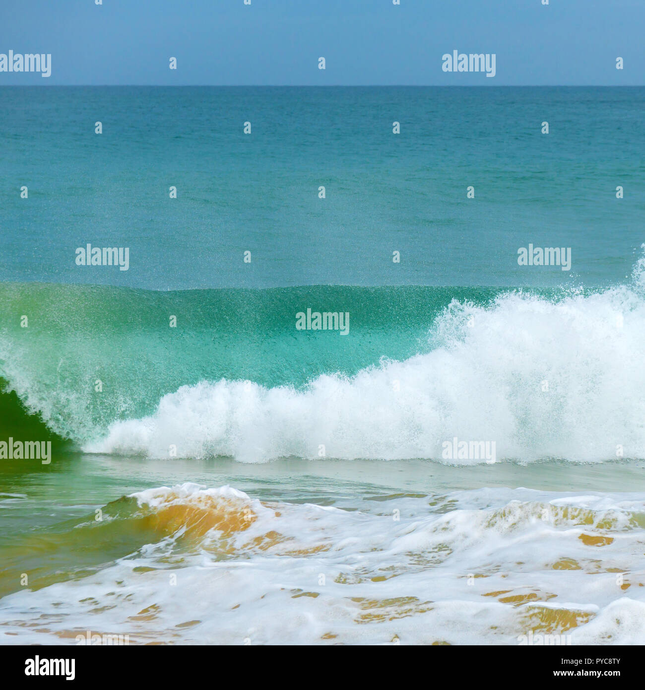 Foam wave, running on the sandy shore Stock Photo - Alamy