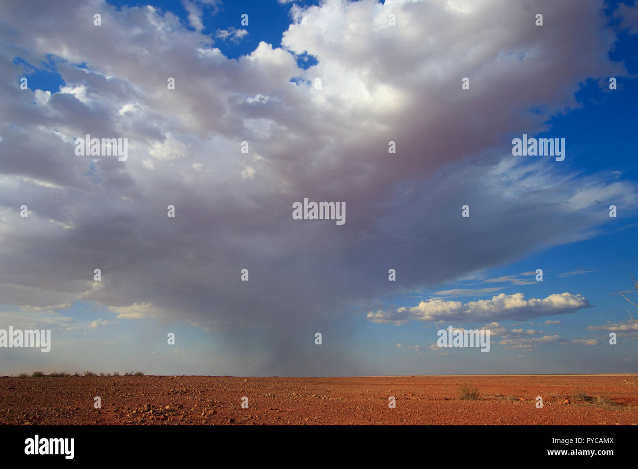 storm clouds and rain over red earth in drought outback Australia Stock ...