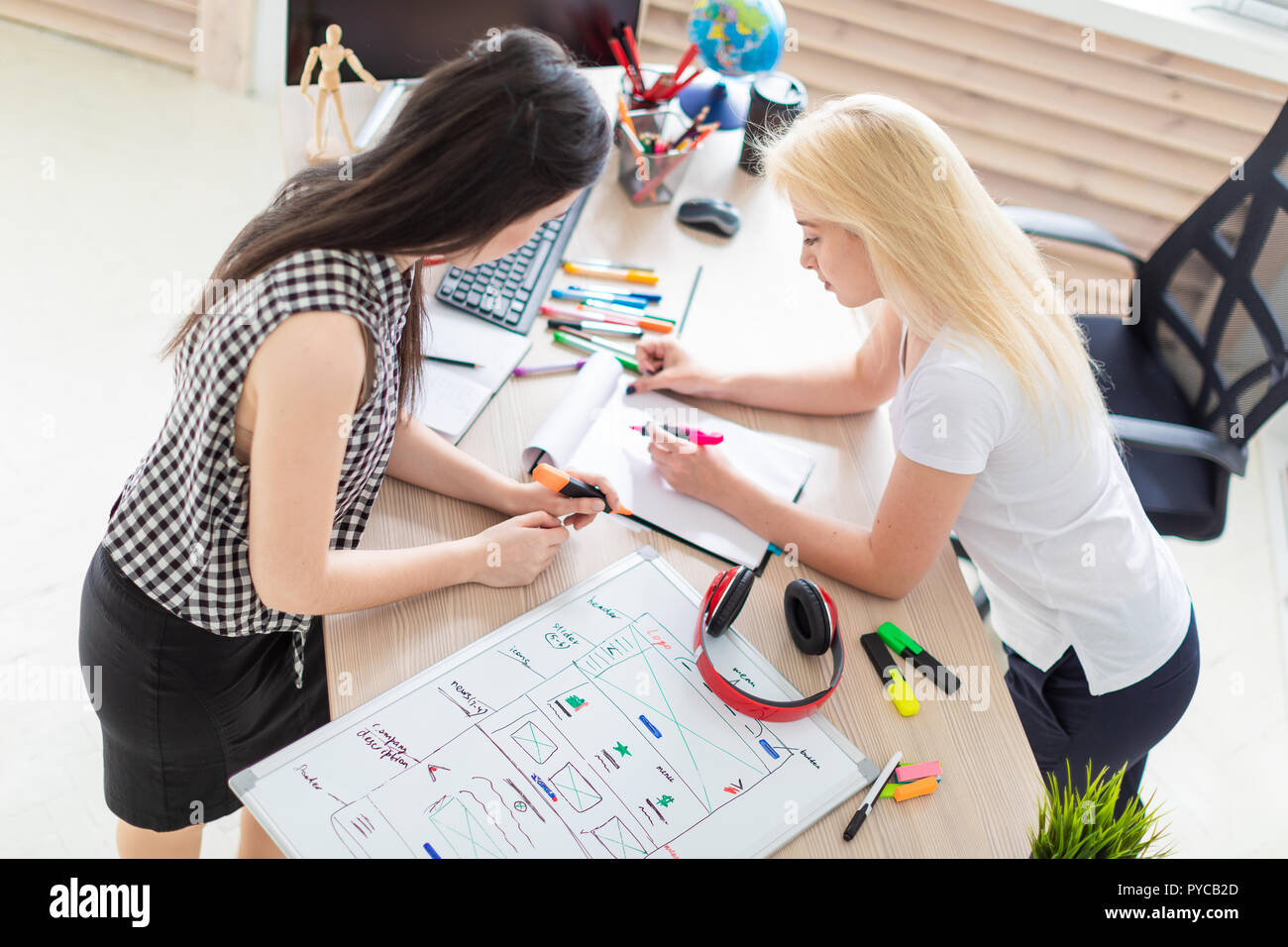 Two girls work in the office Stock Photo - Alamy