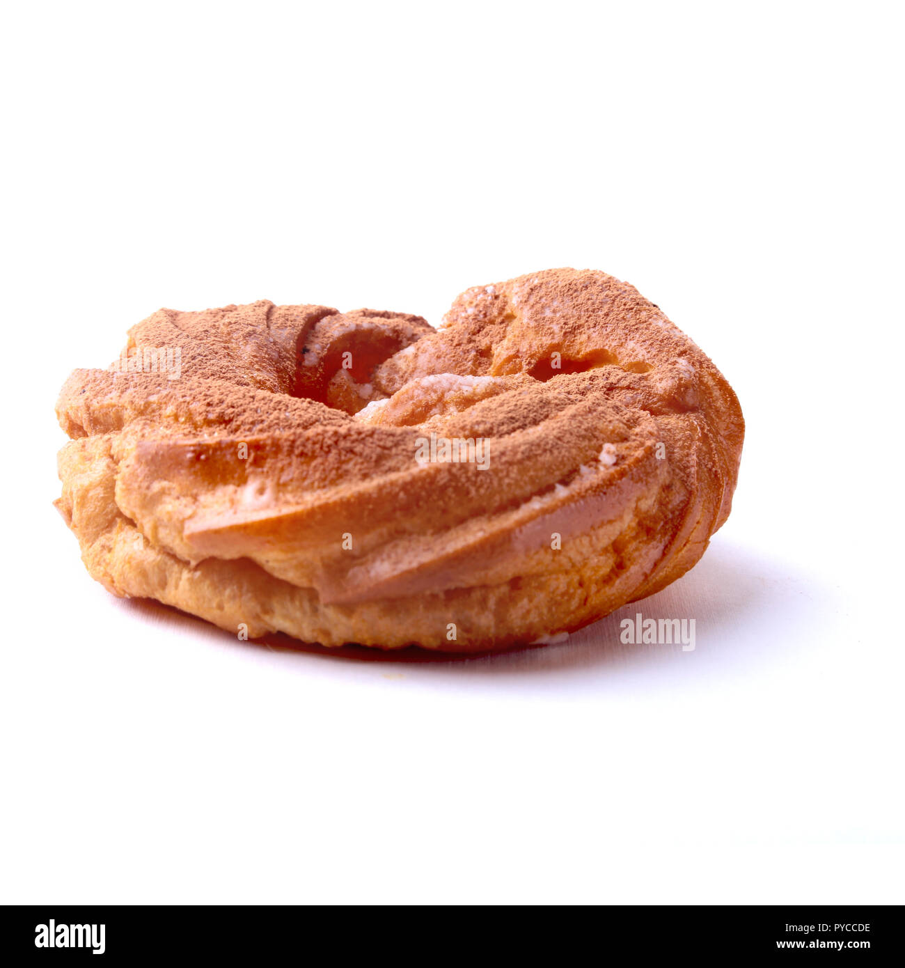 Chocolate and powdered sugar cream puff rings, choux pastry. Isolated ...