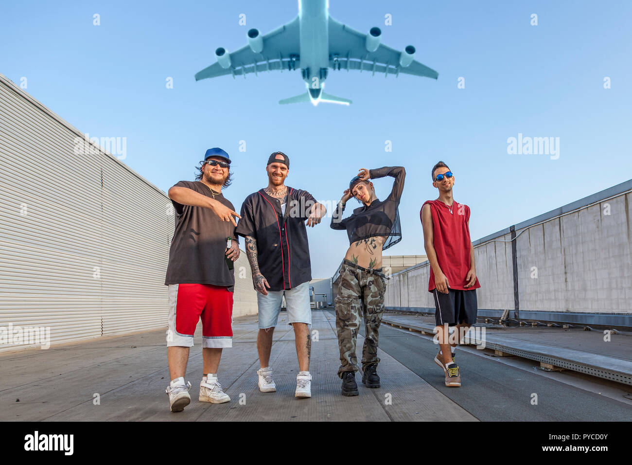 group of rappers posing on the metal rooftops of an abandoned building ...