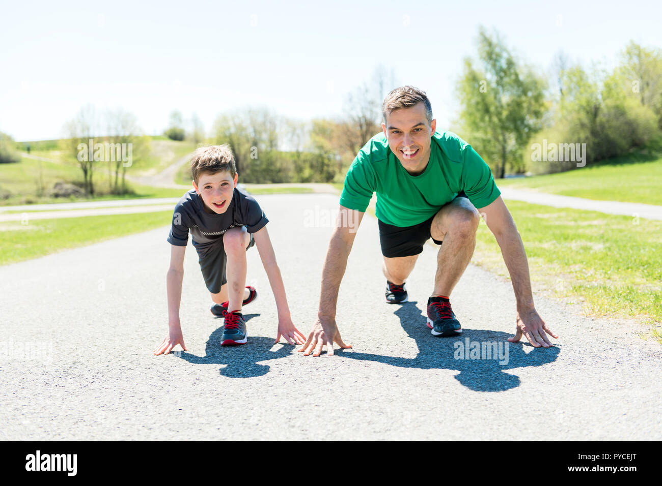 father with son sport running together outside Stock Photo - Alamy