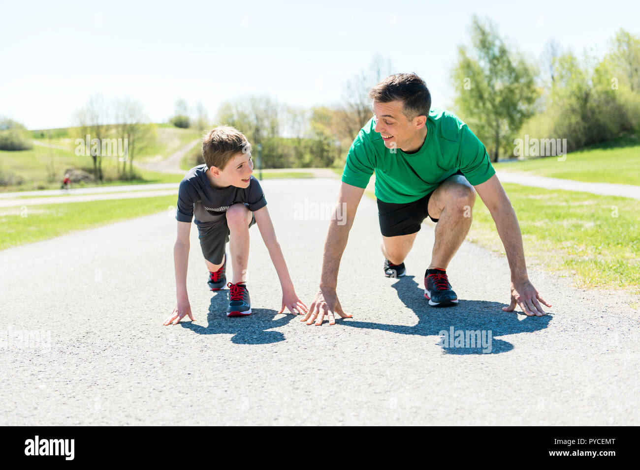 father with son sport running together outside Stock Photo - Alamy