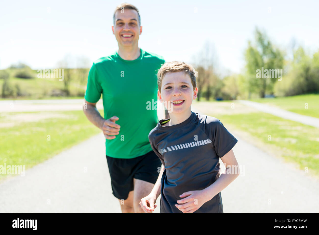 father with son sport running together outside Stock Photo - Alamy