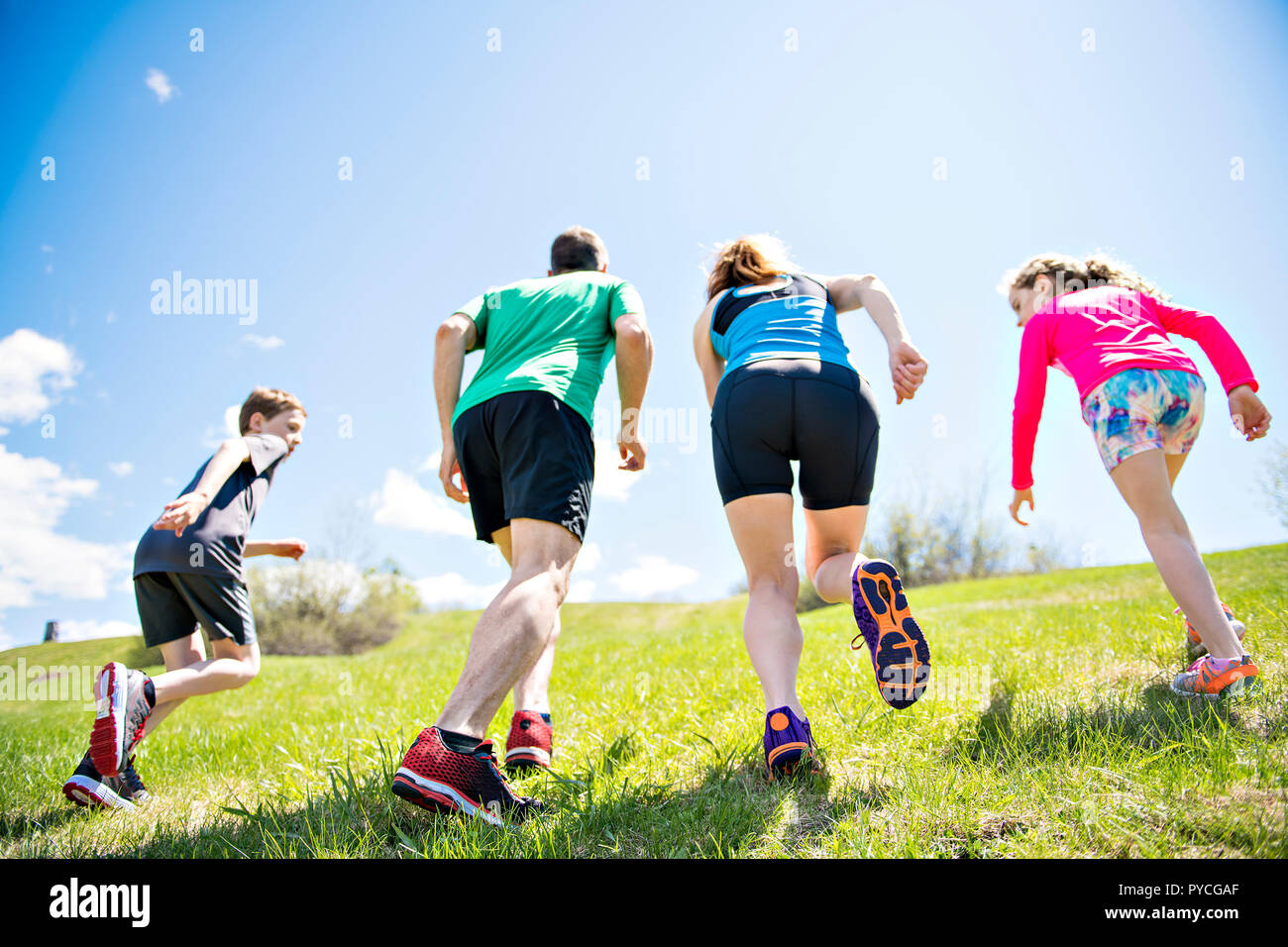 Parents with children sport running together outside Stock Photo - Alamy