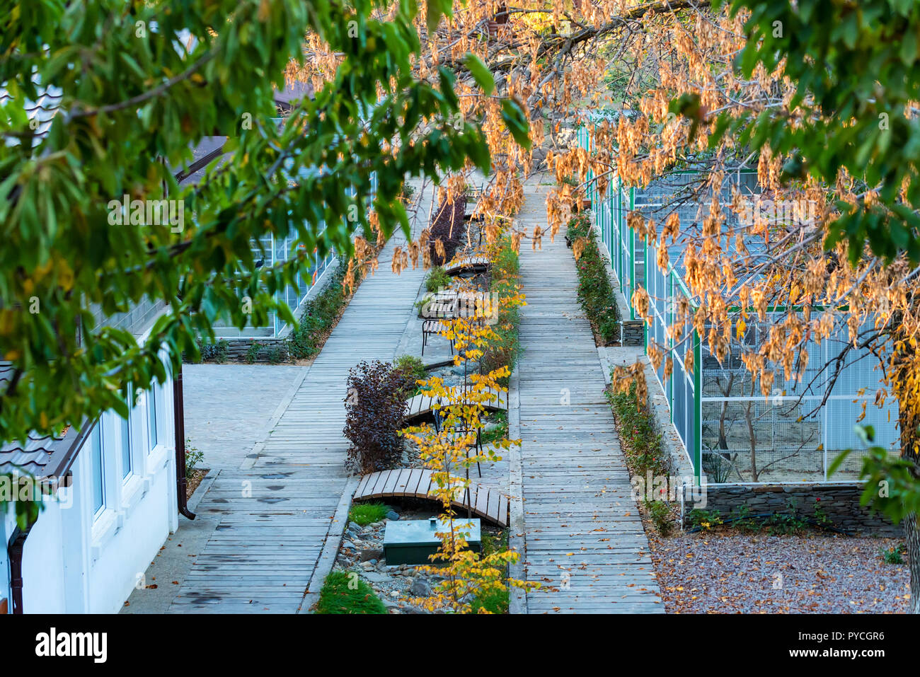 Bird cages in the outdoor zoo with benches Stock Photo - Alamy