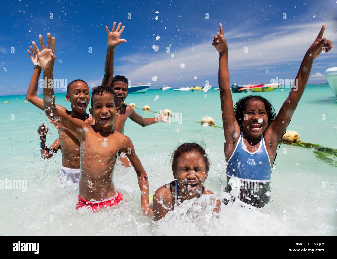Children splashing in the shallows hi-res stock photography and images ...