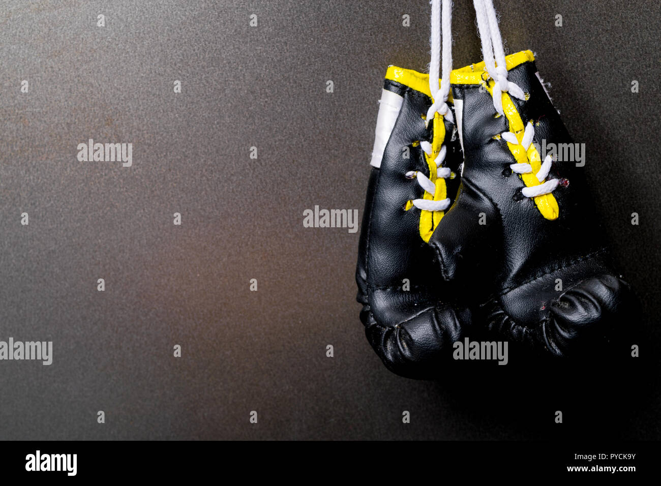 professional black boxing gloves hanging on black background with copy ...