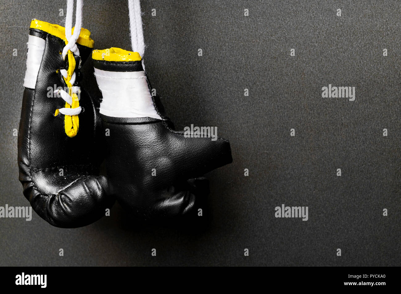 professional black boxing gloves hanging on black background with copy ...