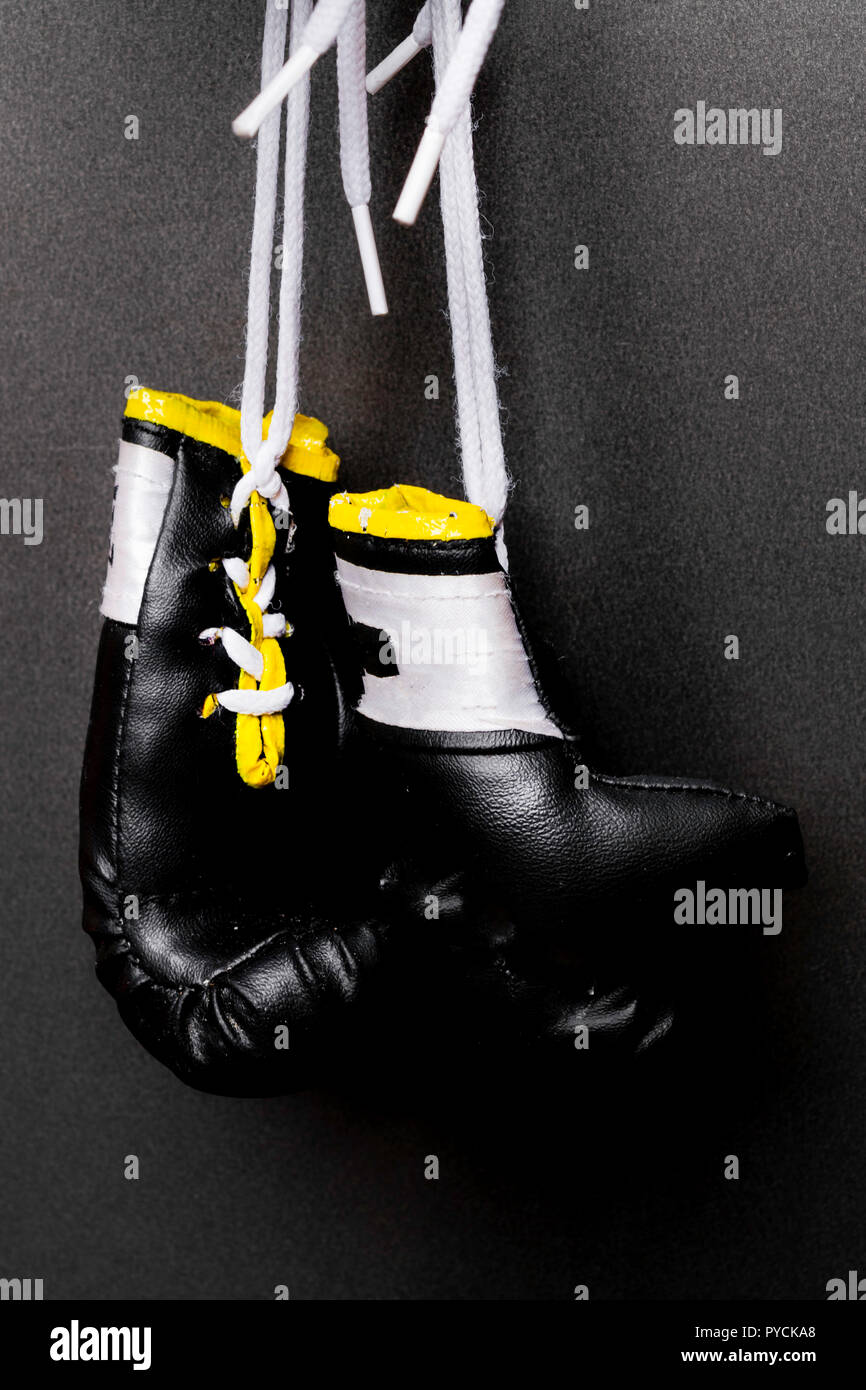 professional black boxing gloves hanging on black background with copy ...