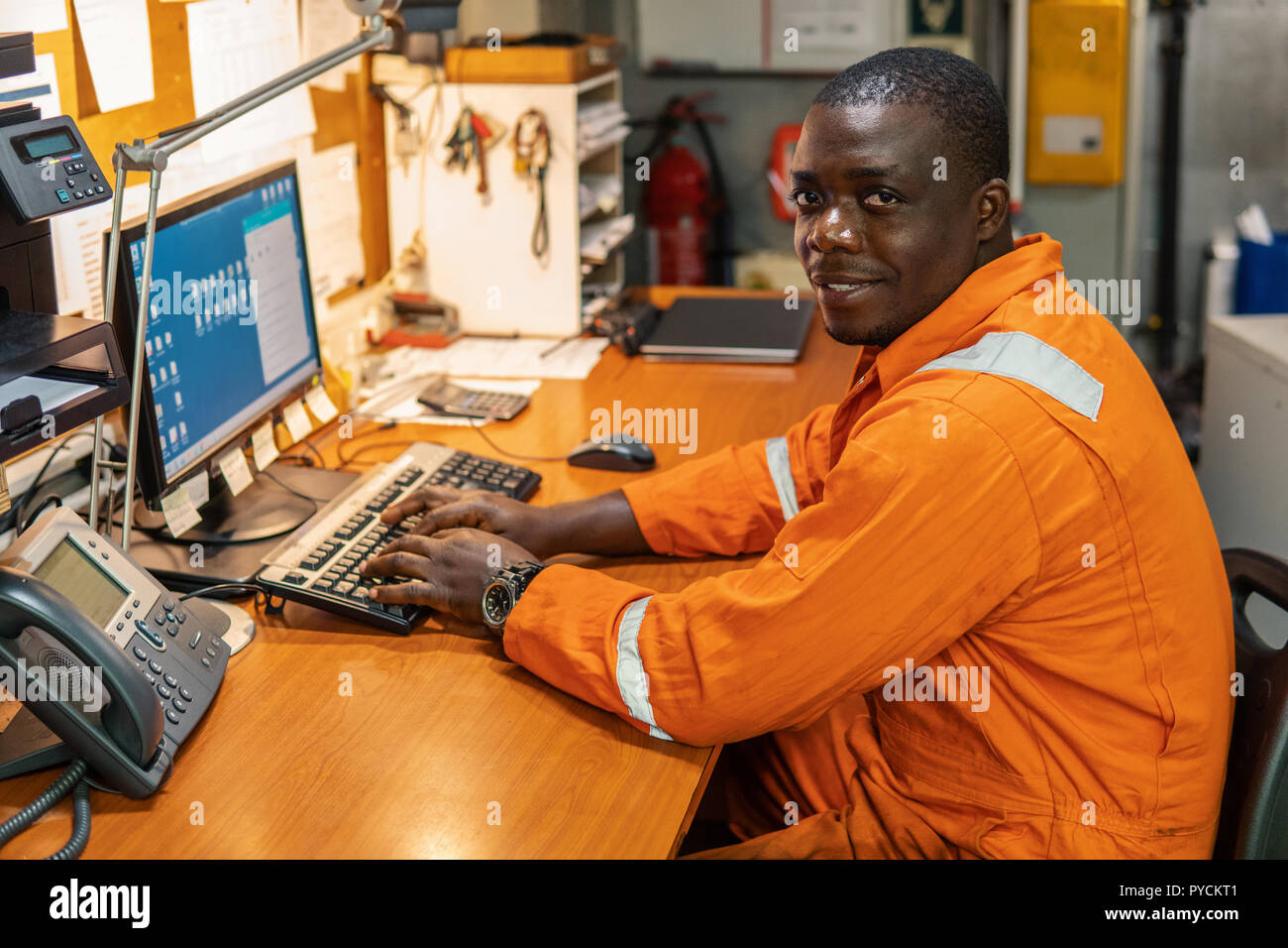 Marine engineer officer working in engine room Stock Photo - Alamy