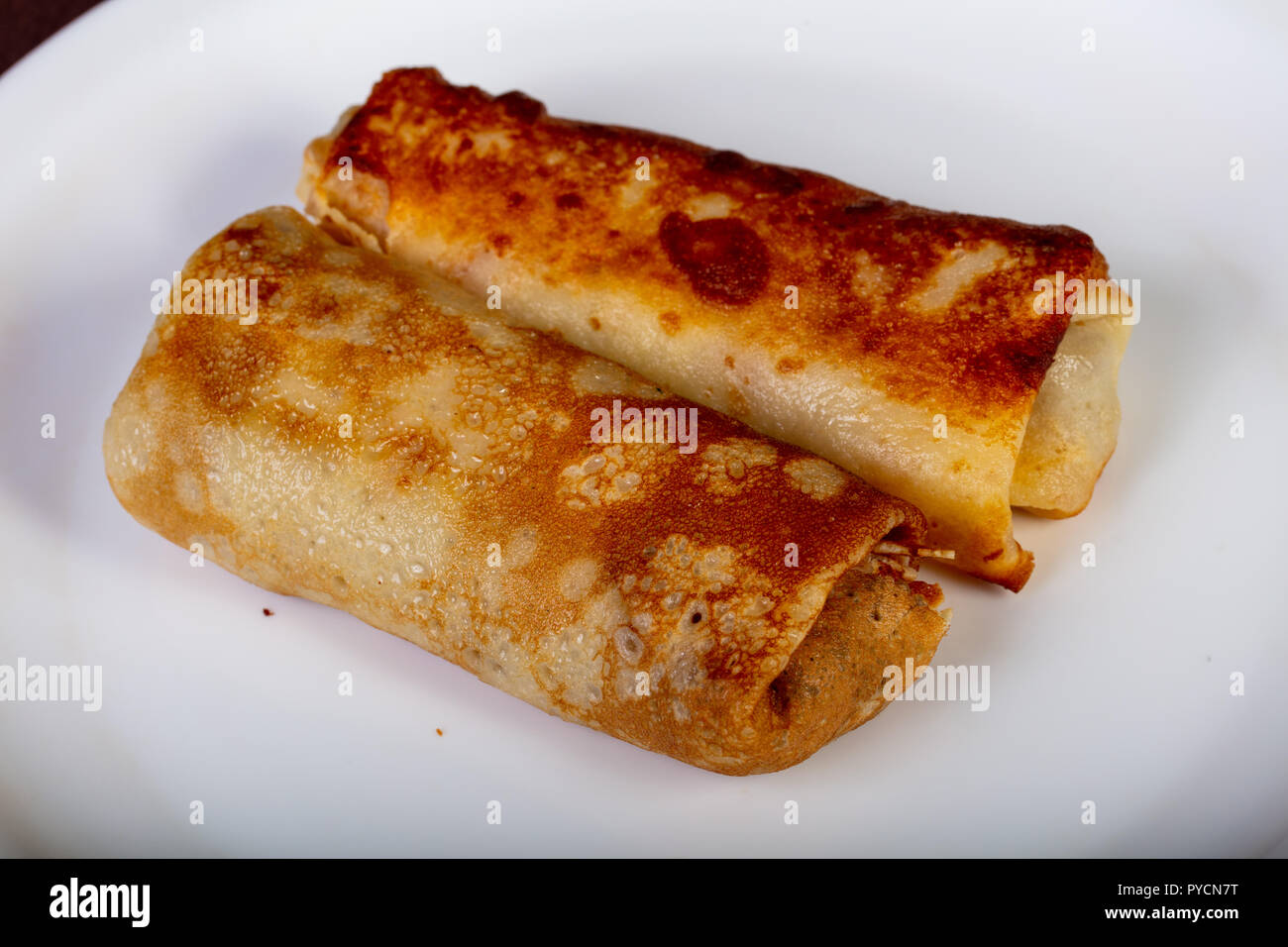Rolled Stuffed pancakes with meat Stock Photo - Alamy