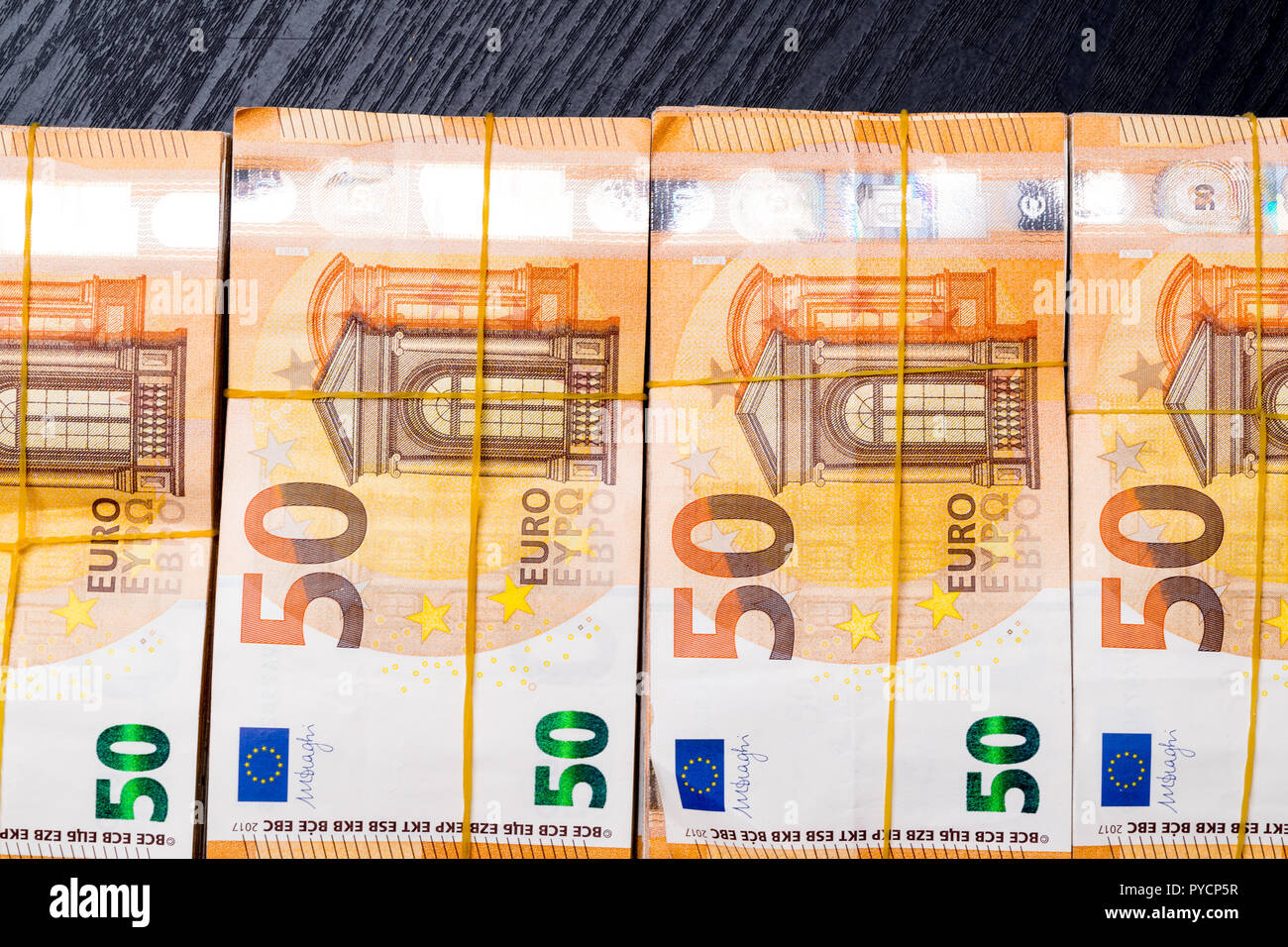 Pile of 50 real euro notes 50-euro banknotes under rubber band ...