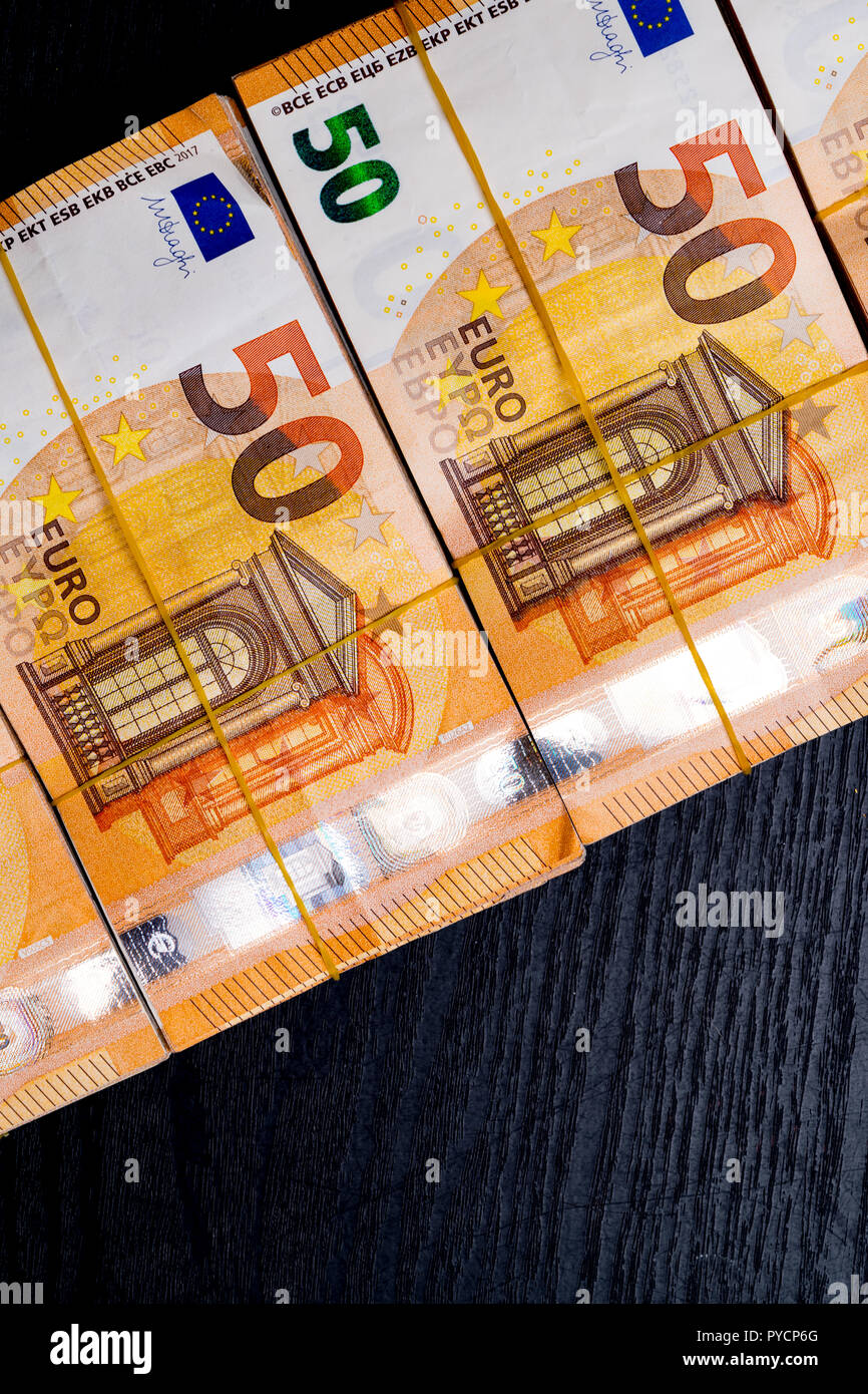 Pile of 50 real euro notes 50-euro banknotes under rubber band ...