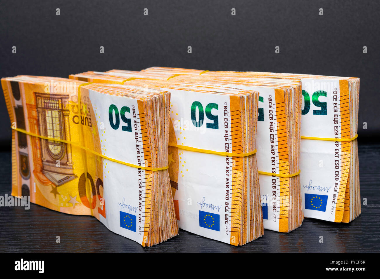 Pile of 50 real euro notes 50-euro banknotes under rubber band ...