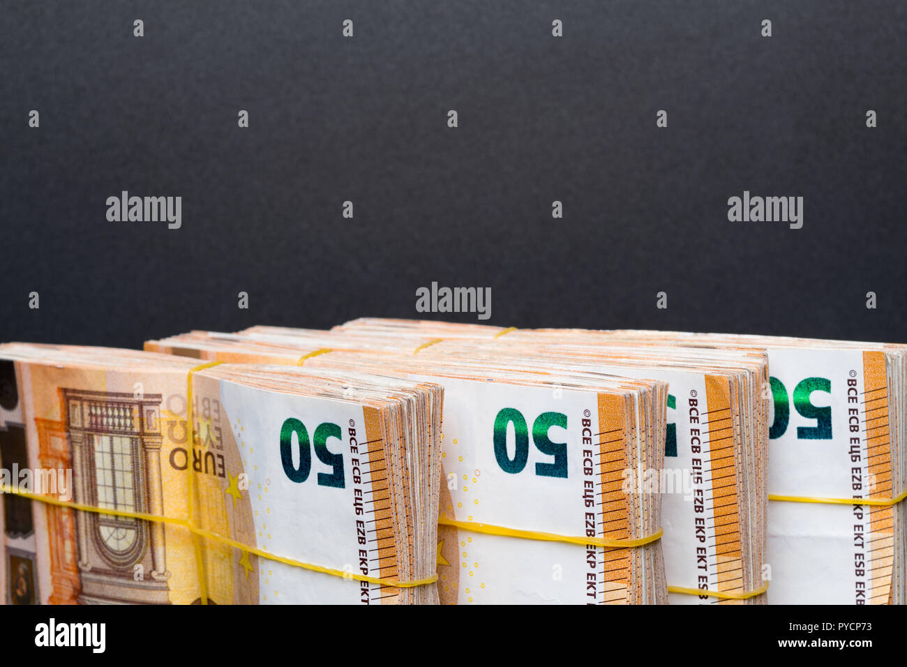 Pile of 50 real euro notes 50-euro banknotes under rubber band ...