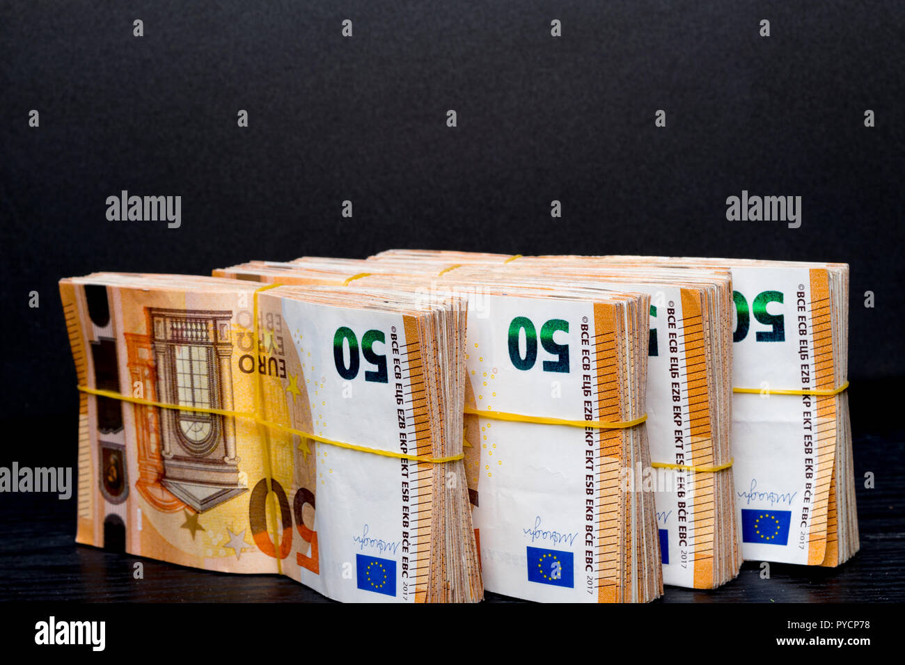 Pile of 50 real euro notes 50-euro banknotes under rubber band ...