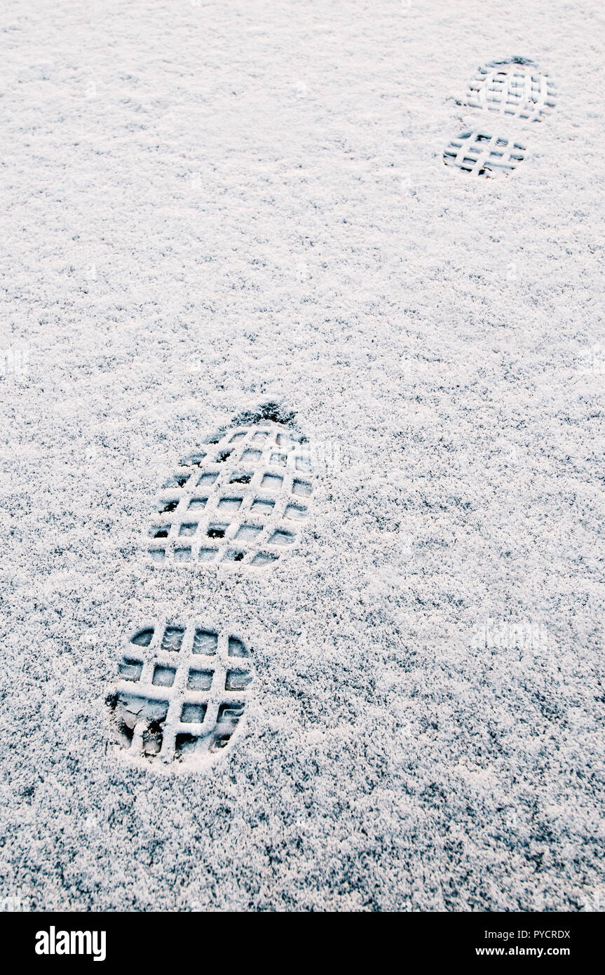 traces of a man walking in the snow in winter, Italy Stock Photo - Alamy