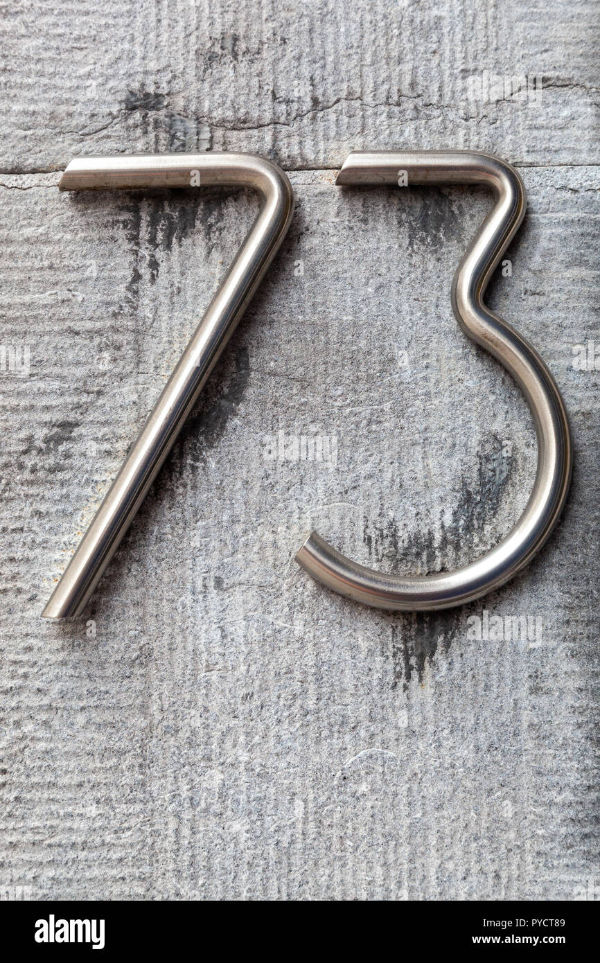 House number seventy-three 73 in curved and twisted metal - stainless ...