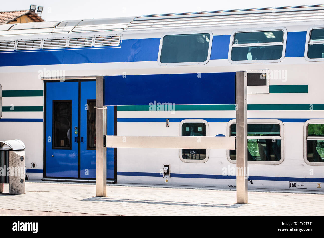 European train arriving to the station with a blank station sign Stock ...