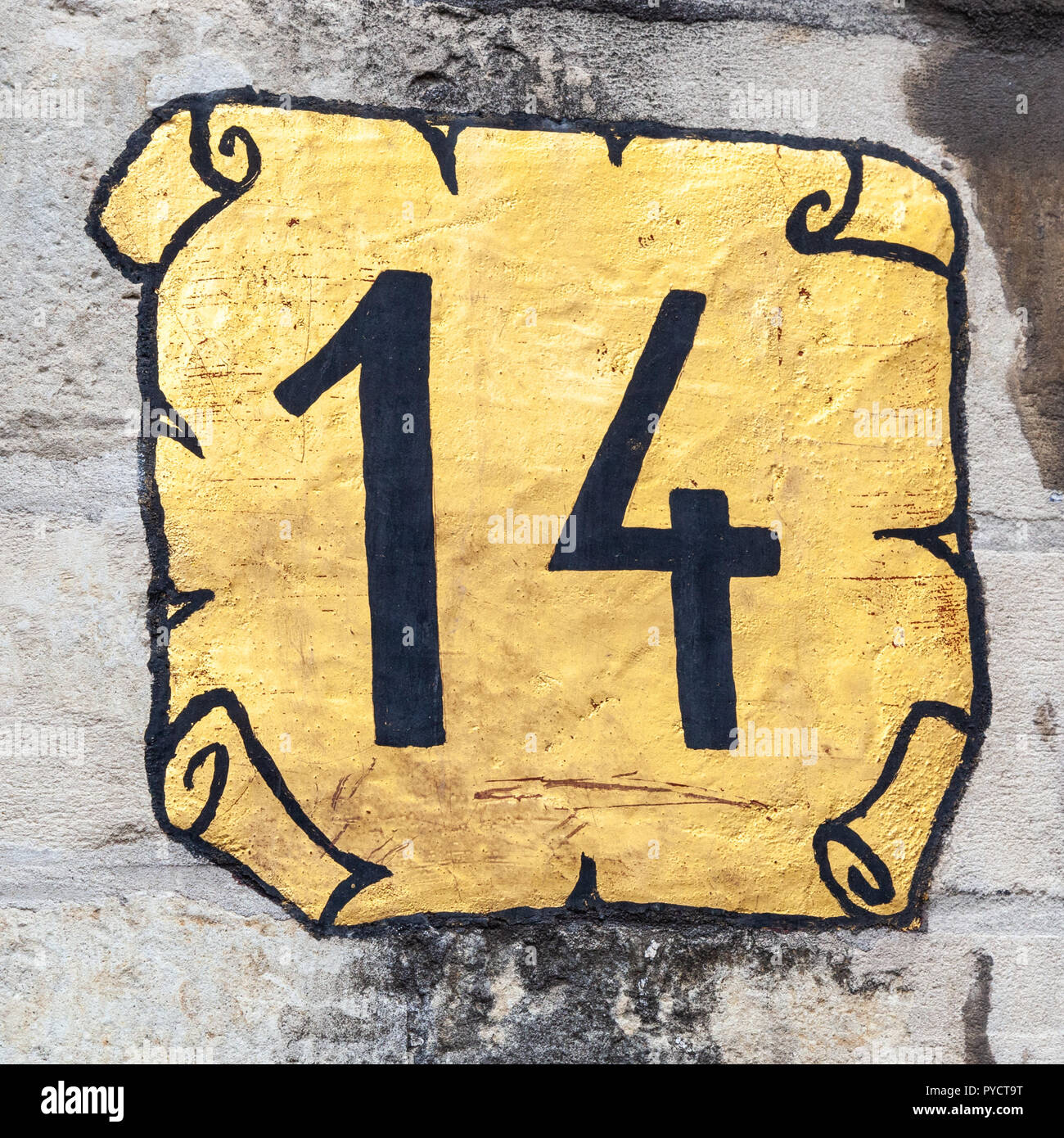 House number fourteen 14 painted black on gold in a square scroll ...