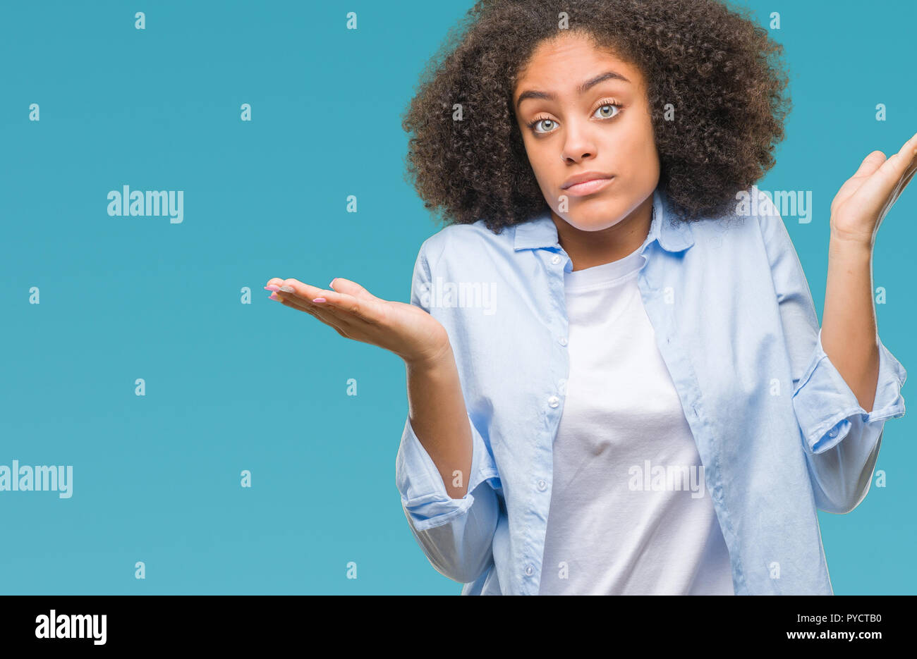 Young afro american woman over isolated background clueless and ...