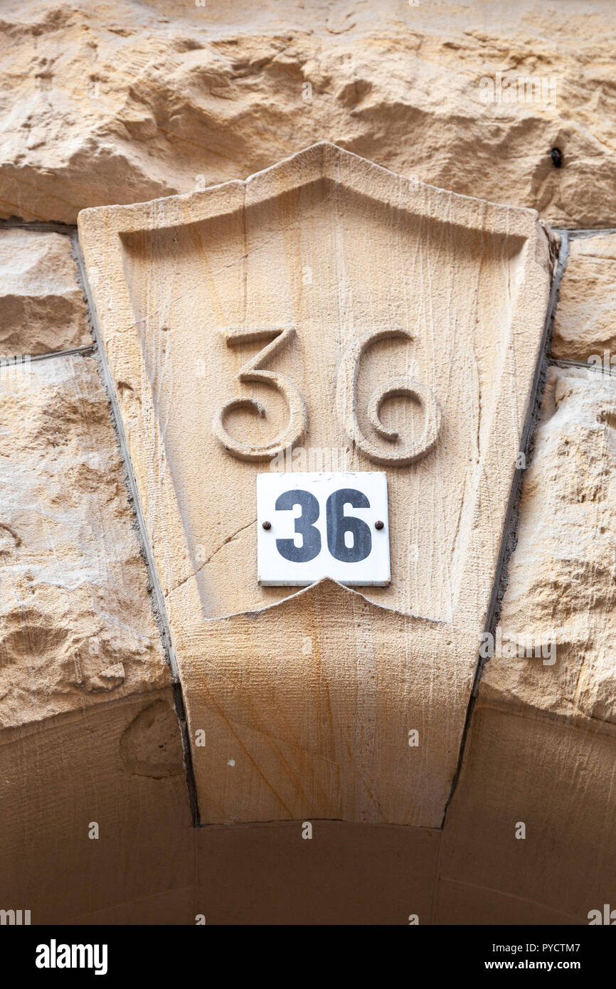House number thirty-six 36 in stylized concrete plaque with concrete ...