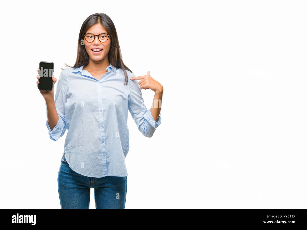 Young asian woman showing smartphone blank screen over isolated ...