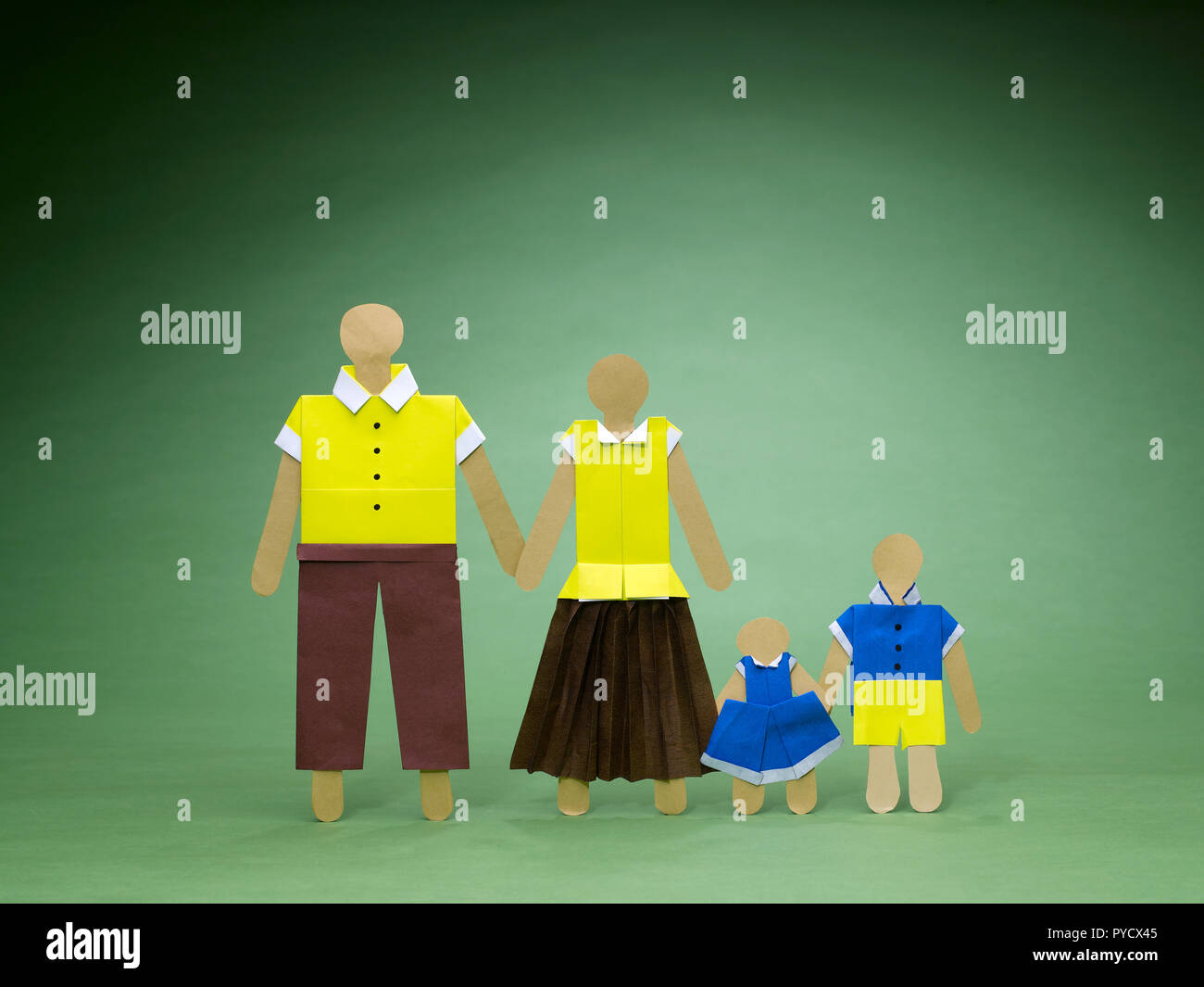 FAMILY OF FOUR USING THE ART OF ORIGAMI Stock Photo - Alamy
