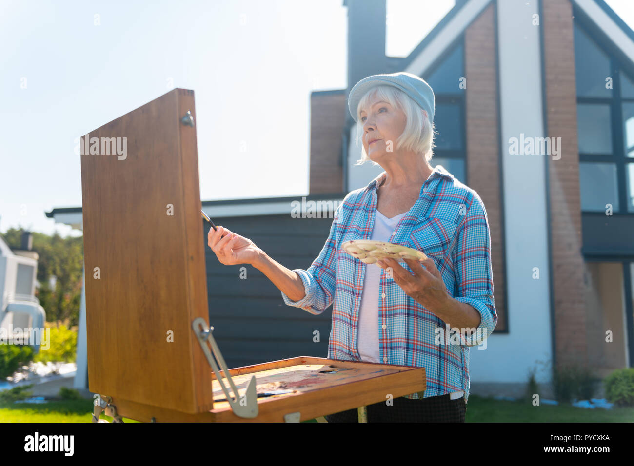 Elderly retired artist having some inspiration while drawing still life ...