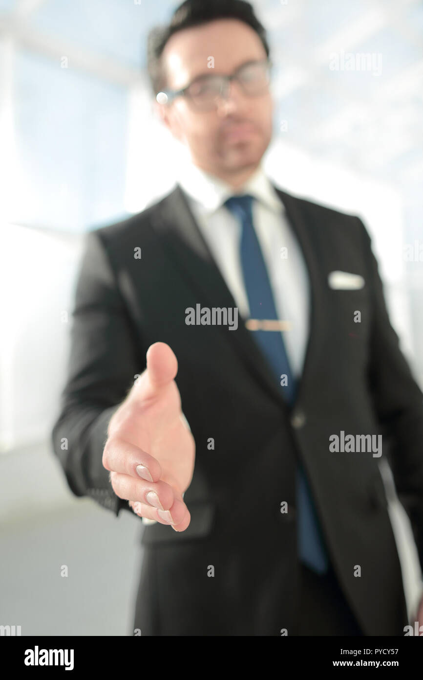 businessman holding out his hand for a handshake Stock Photo - Alamy