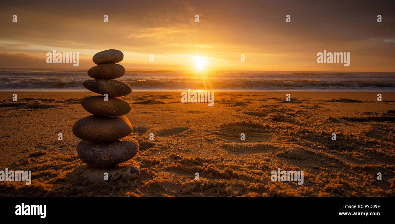 Pebble stack on Scratby beach at Sunrise Stock Photo - Alamy