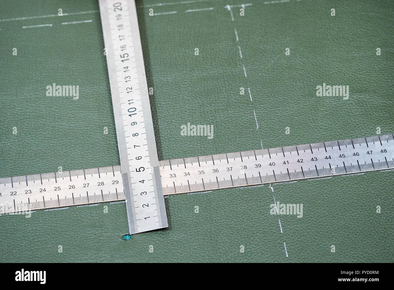 workshop of making textile and leather travel bag - steel rulers on ...