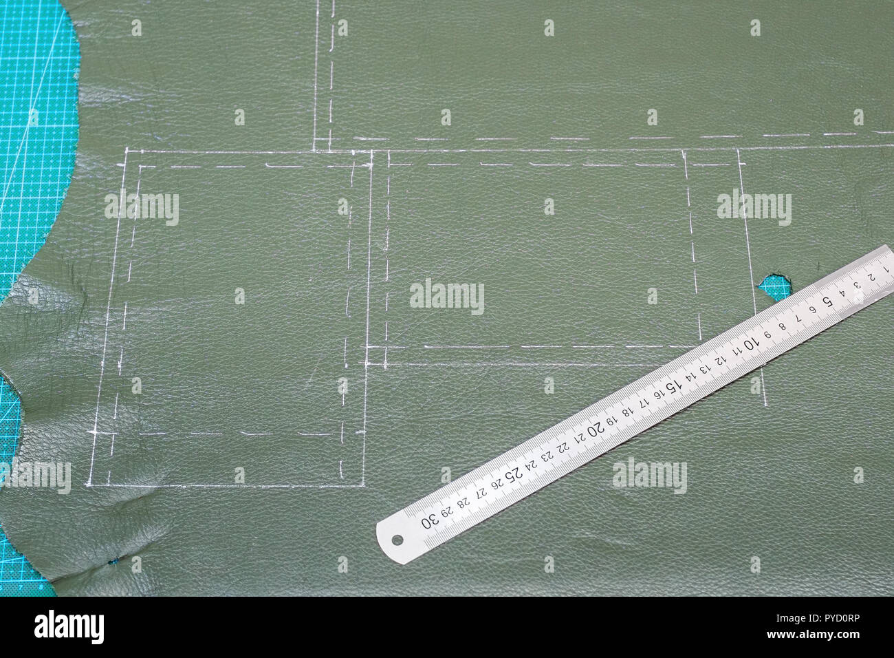 workshop of making textile and leather travel bag - steel ruler on ...