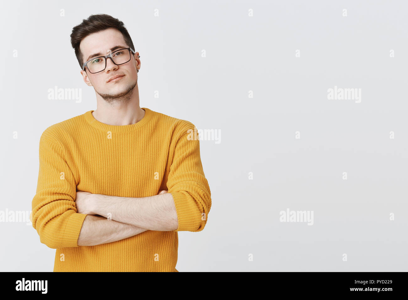 Portrait of serious-looking handsome and smart young man in glasses and ...