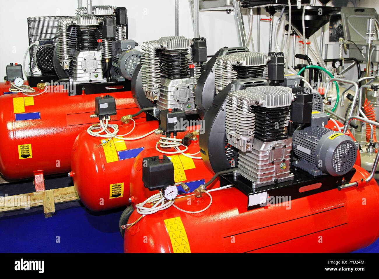Red air compressors for garage work shop Stock Photo - Alamy