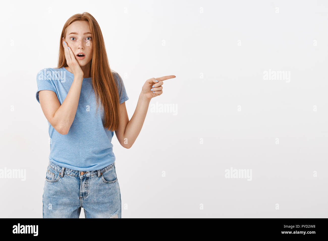 Portrait of shocked and surprised caucasian redhead lady with freckles ...