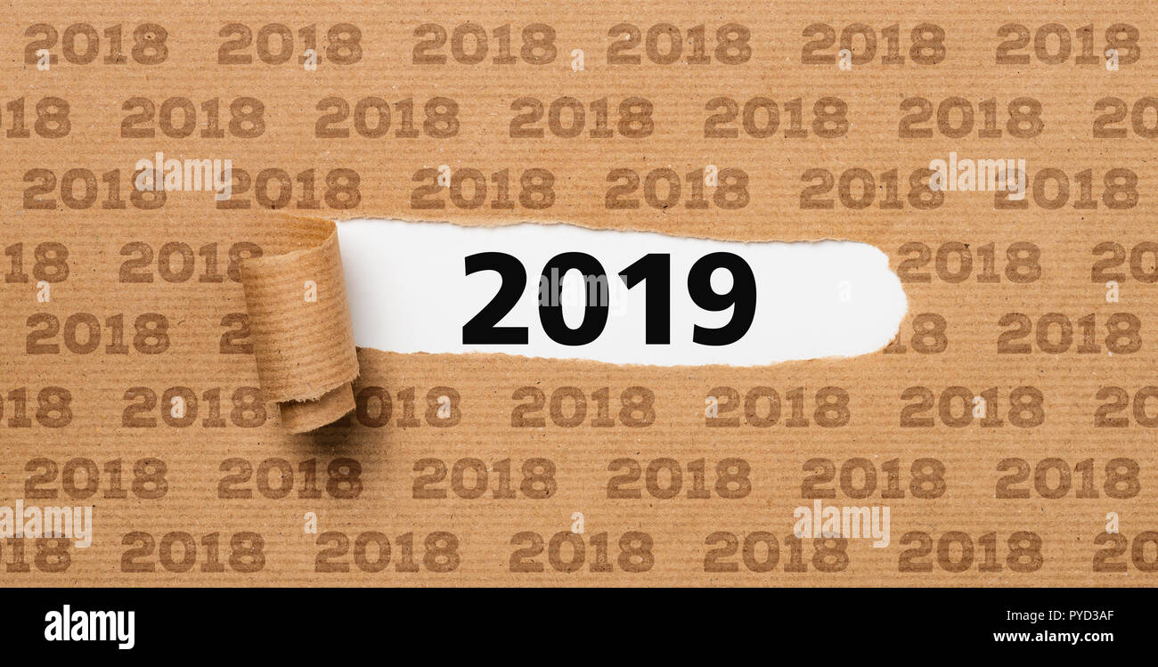 Torn green paper revealing the number 2019 Stock Photo - Alamy