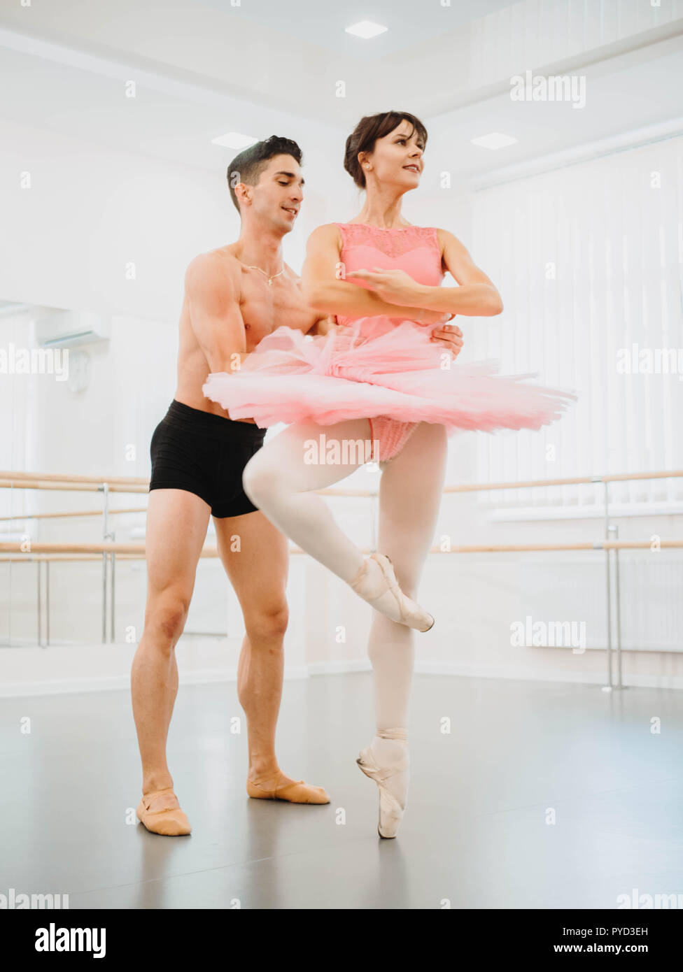 Professional, emotional ballet dancers practicing in the gym or hall ...