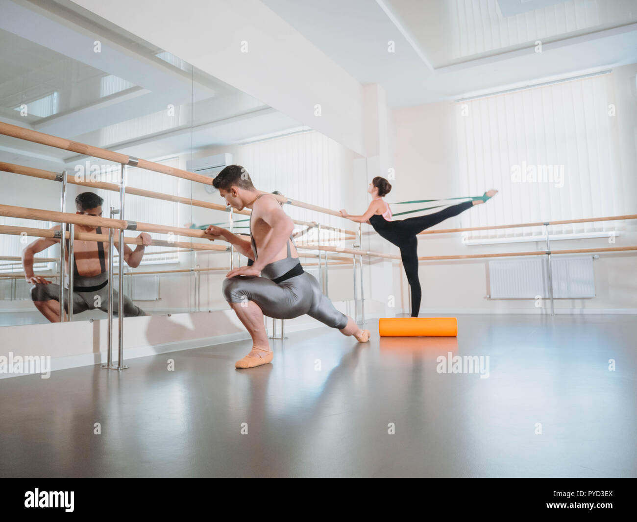 Preparation of body before performance in ballet studio. Male dancer ...